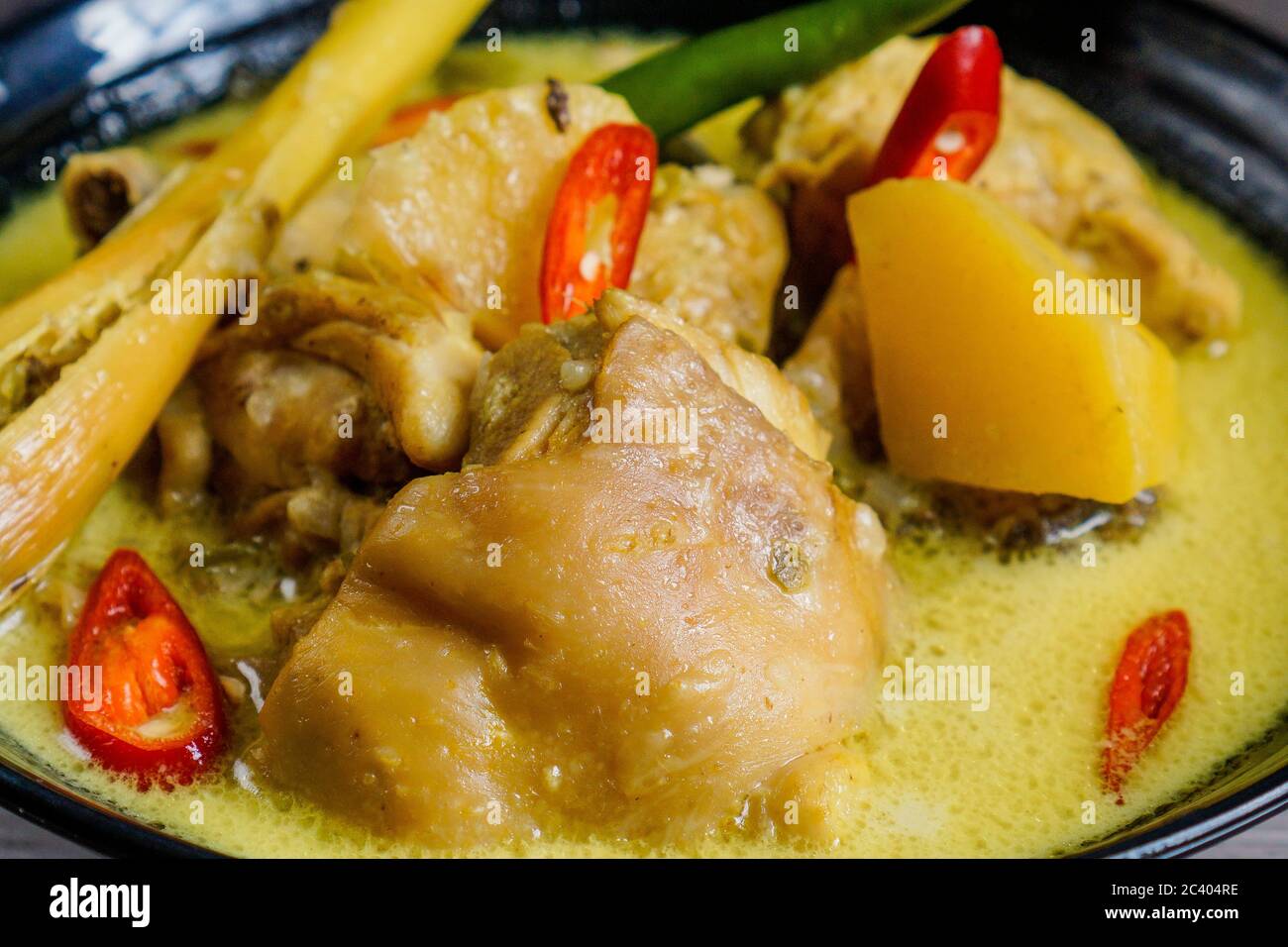 Chicken in turmeric coconut curry with spicy bird chili or thai chili ...