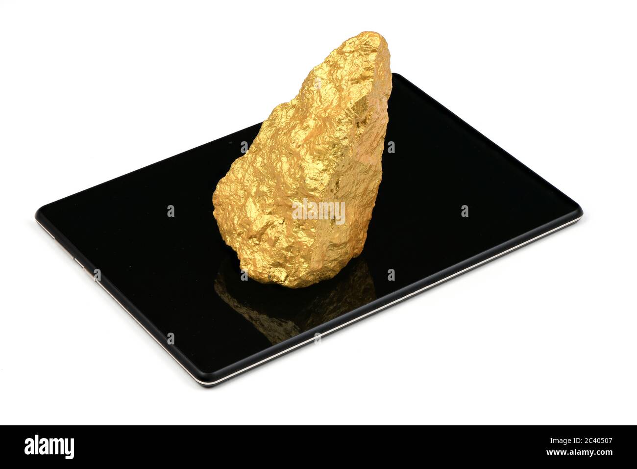 Gold nugget on tablet pc isolated on white background. High resolution ...
