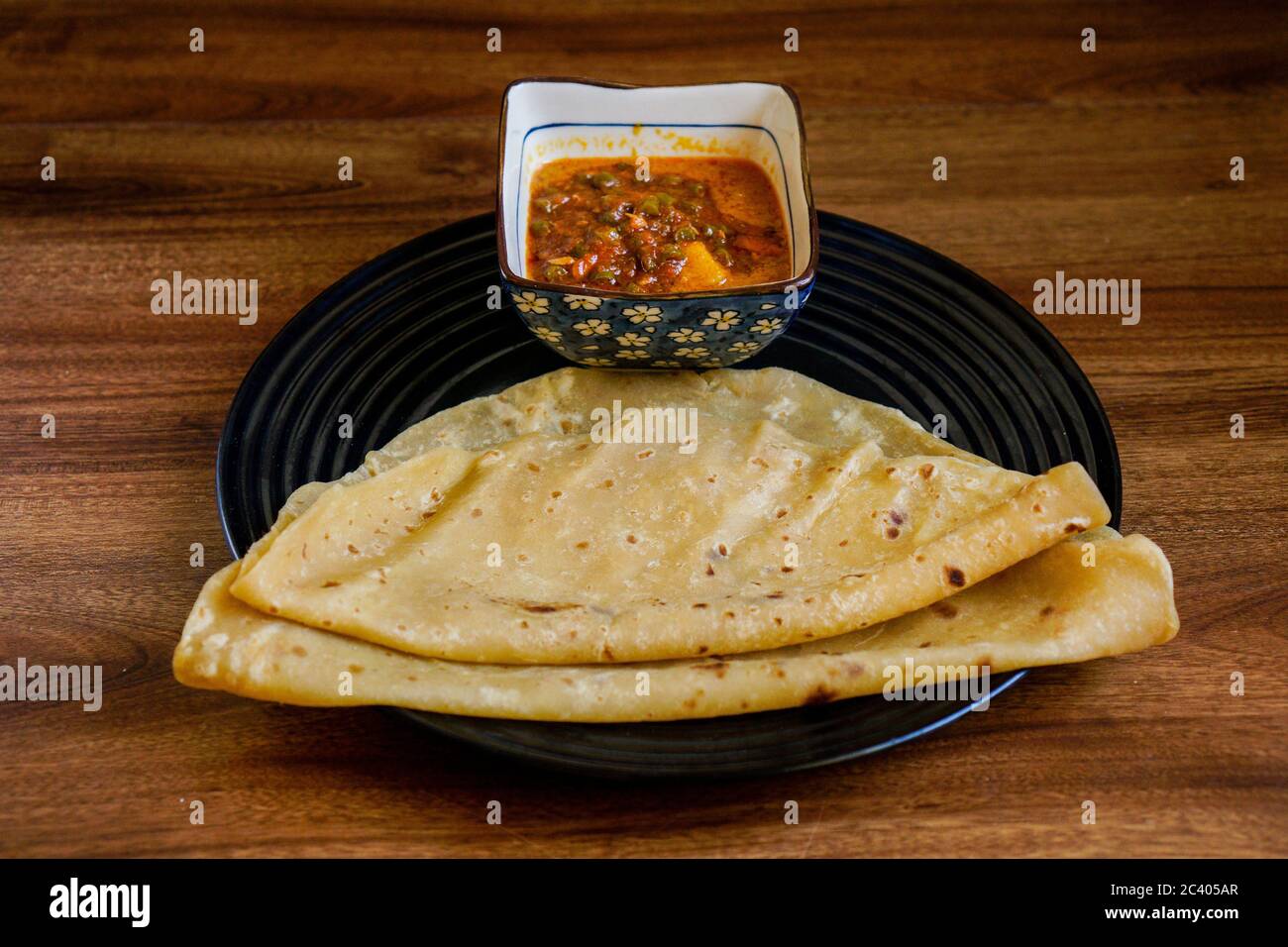 Chapati with chicken curry mix with sardine sambal Stock Photo - Alamy
