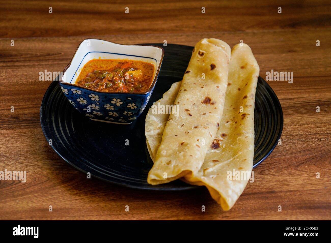 Chapati with chicken curry mix with sardine sambal Stock Photo - Alamy