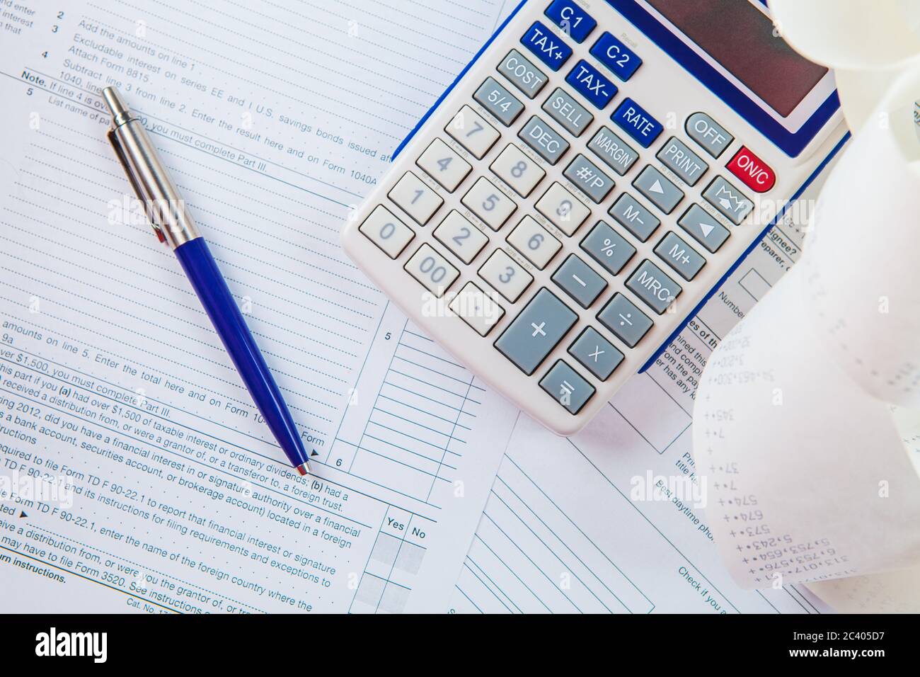 Tax form, calculator and pen Stock Photo - Alamy