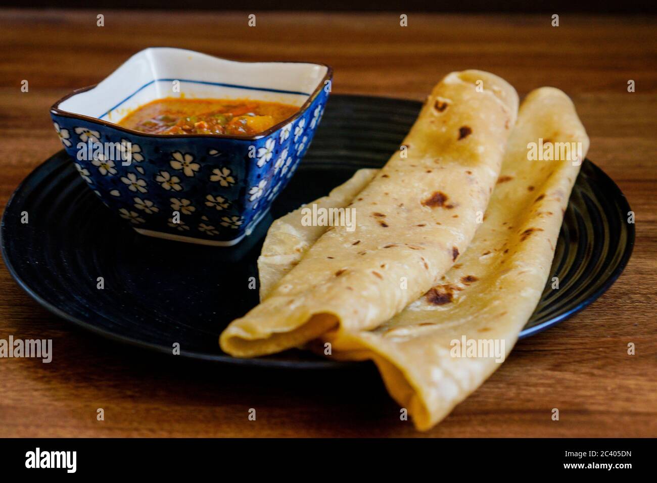 Chapati with chicken curry mix with sardine sambal Stock Photo - Alamy