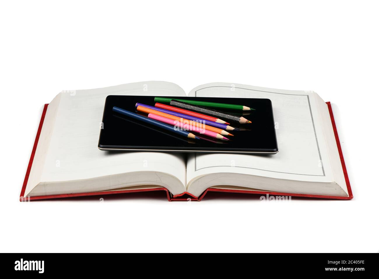 Tablet pc on opened book isolated on white background. High resolution ...