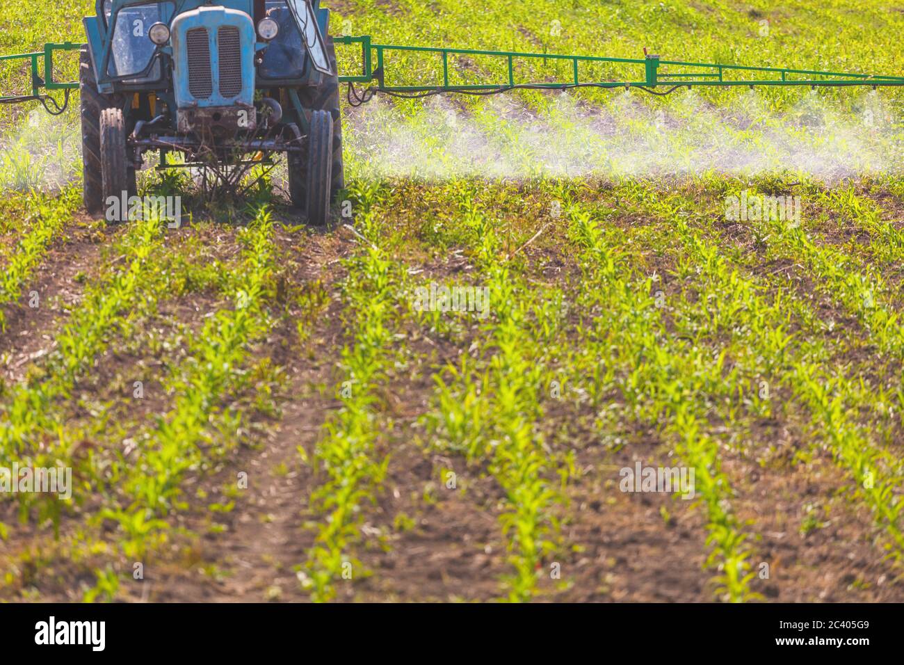 A tractor field sprayer spreading herbicide onto field Stock Photo - Alamy