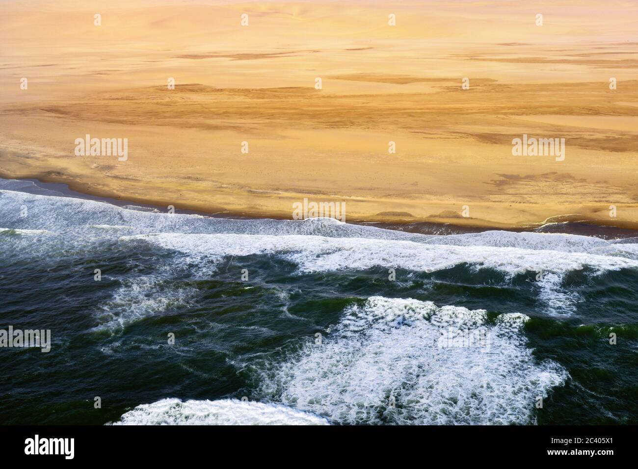 Aerial view on the coast in Namibia where dunes of the Namib desert ...