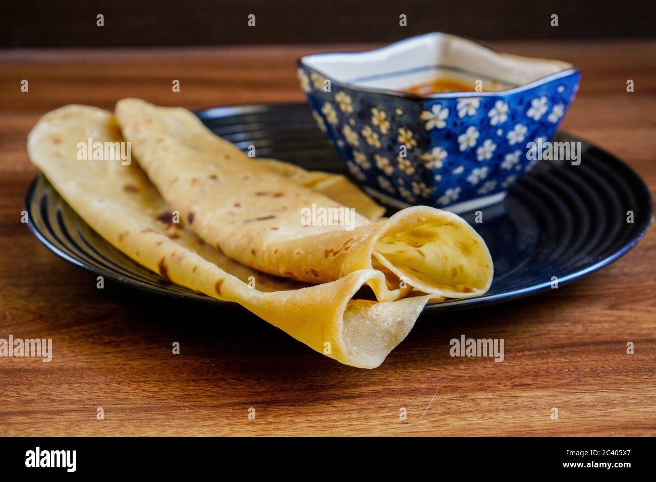 Chapati with chicken curry mix with sardine sambal Stock Photo - Alamy