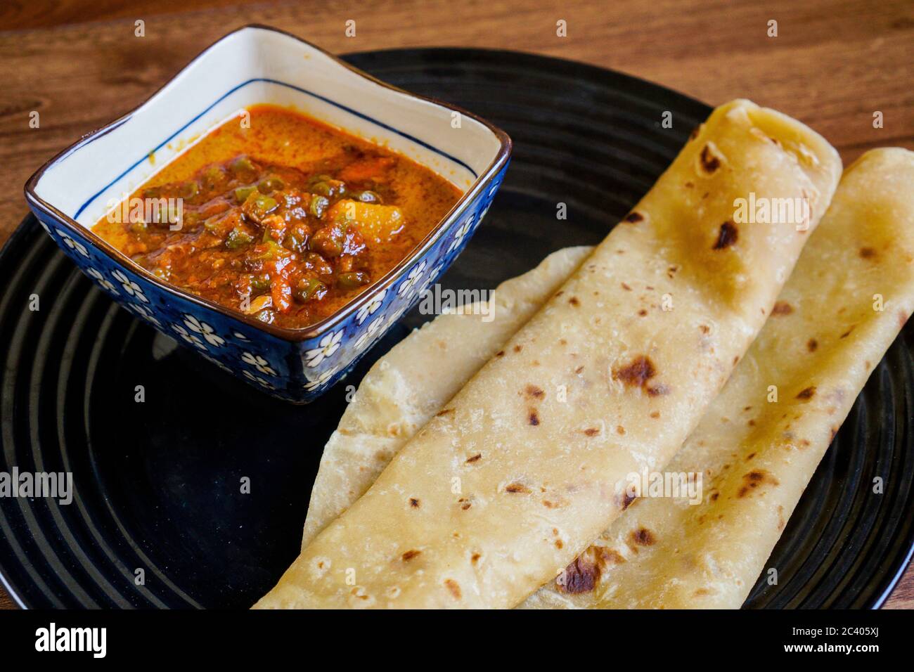 Chapati with chicken curry mix with sardine sambal Stock Photo - Alamy
