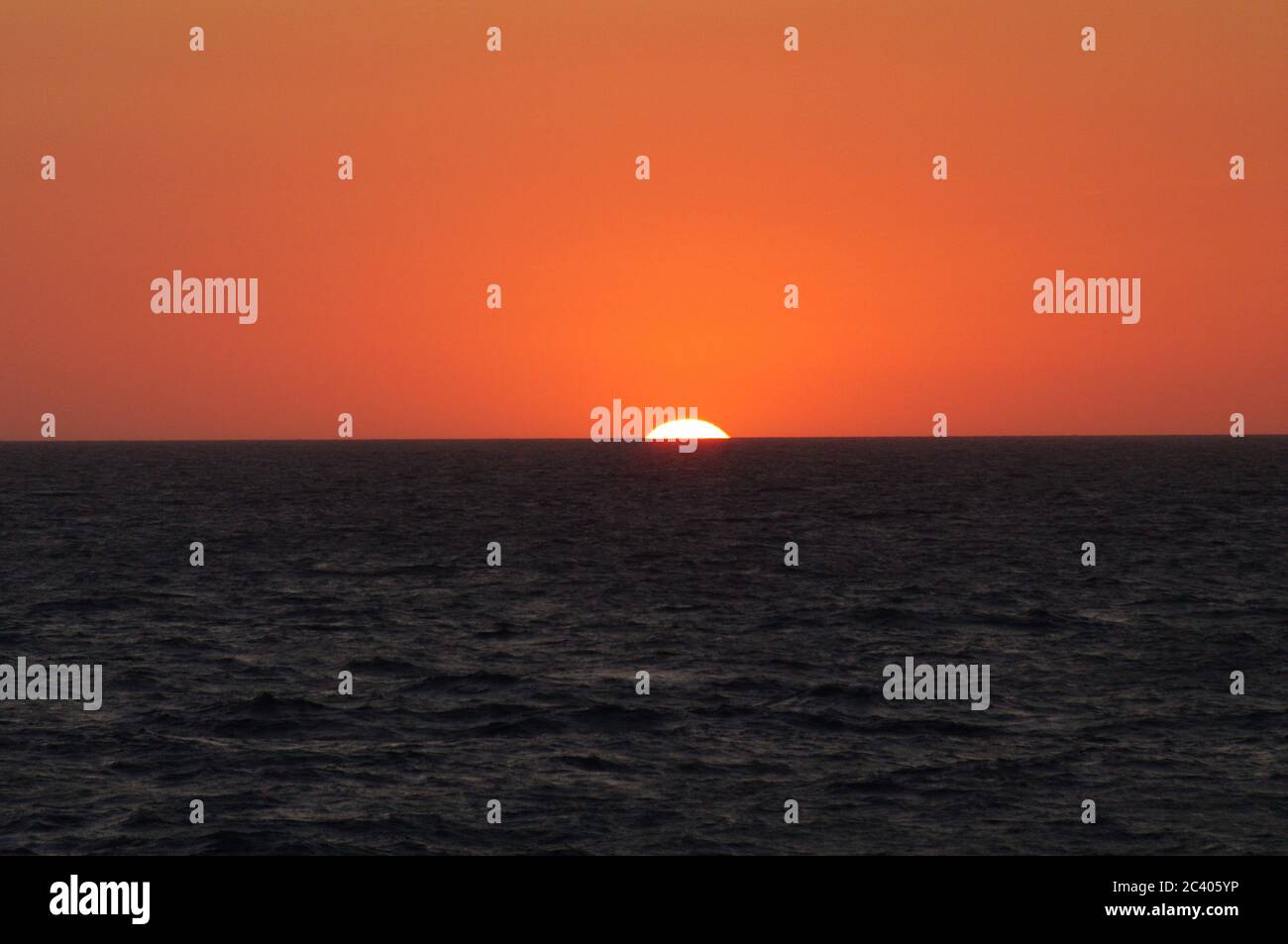 Series of images of sunsetting over ocean,Yellow orb sinking into the ...
