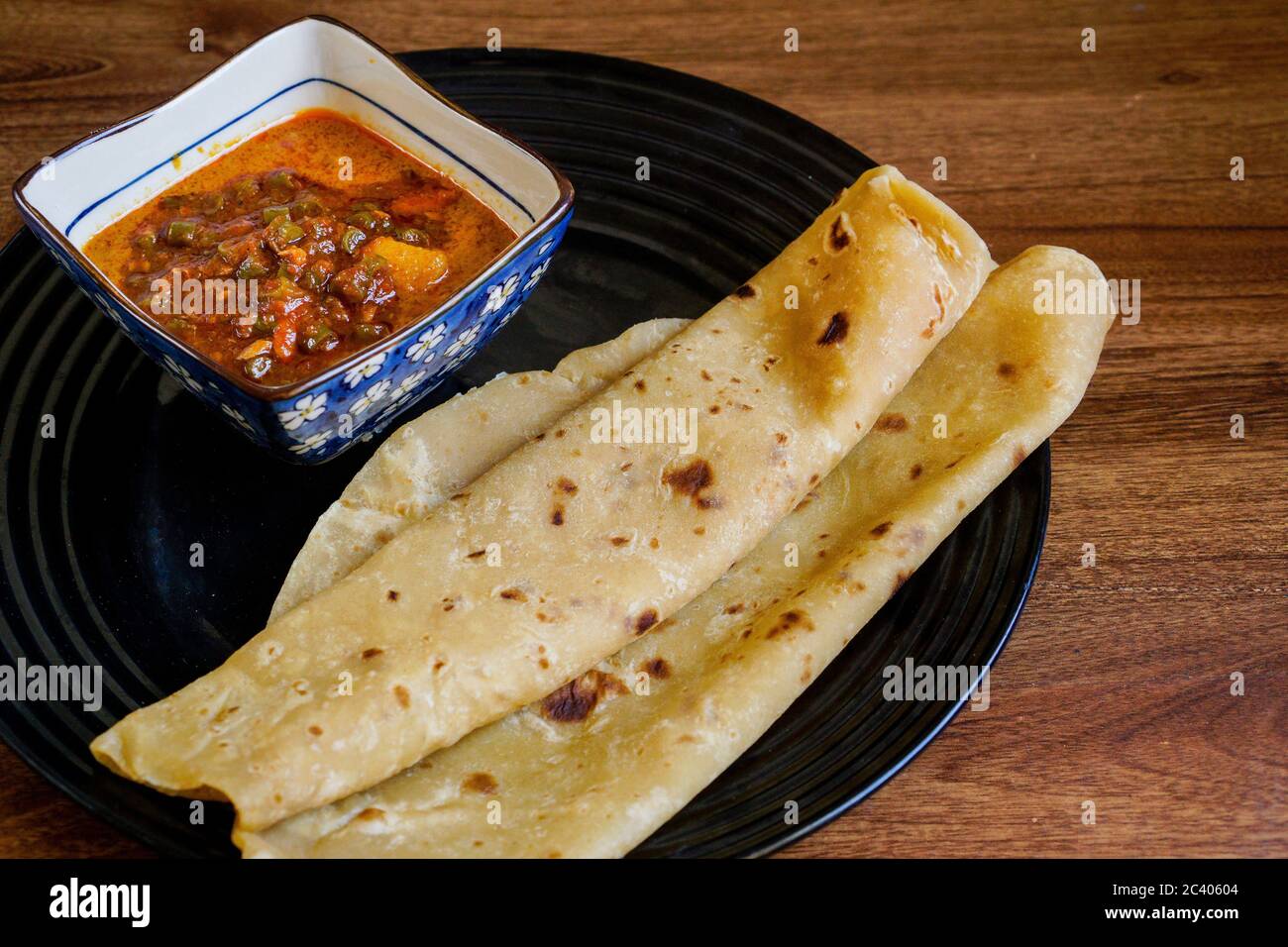 Chapati with chicken curry mix with sardine sambal Stock Photo - Alamy