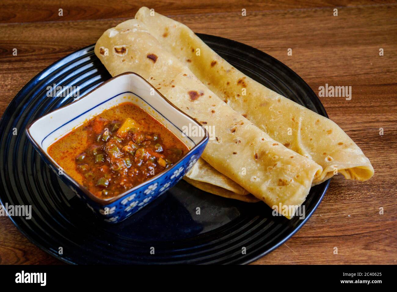 Chapati with chicken curry mix with sardine sambal Stock Photo - Alamy