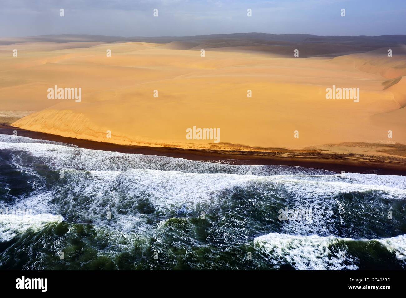 Aerial view on the coast in Namibia where dunes of the Namib desert ...