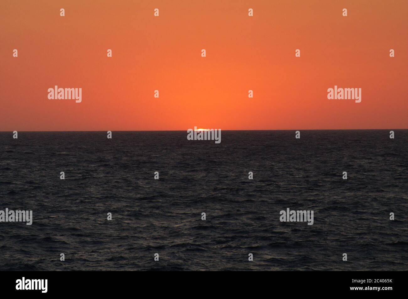 Series of images of sunsetting over ocean,Yellow orb sinking into the ...
