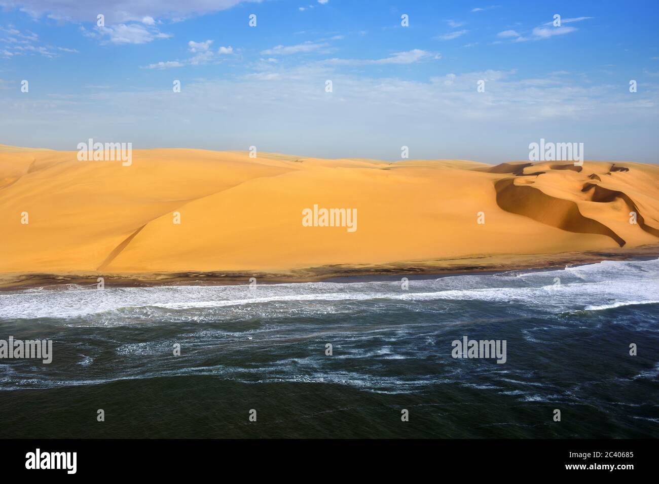 Aerial view on the coast in Namibia where dunes of the Namib desert ...