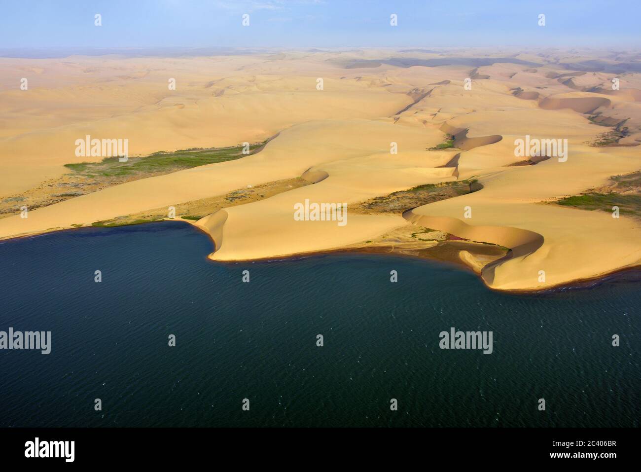 Aerial view on the coast in Namibia where dunes of the Namib desert ...