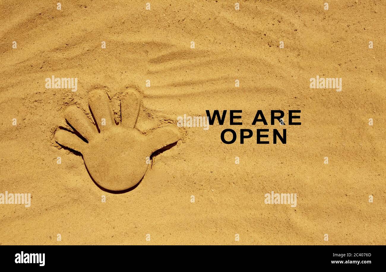 End of quarantine. Text message W are open on the sand. Welcome sign on ...