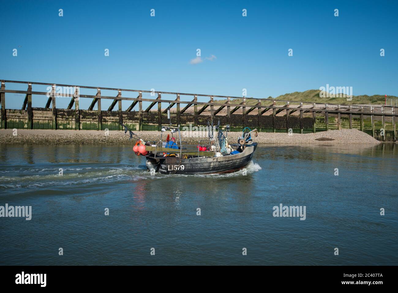 Fishing trawler returns to harbour on a summers day. Littlehampton ...