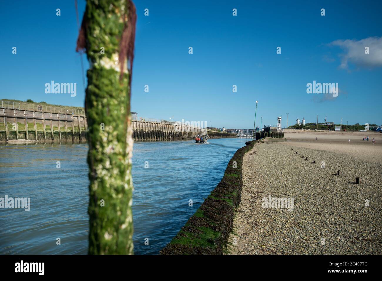 Littlehampton Harbour Sussex. A boat enters the harbour on a sunny ...