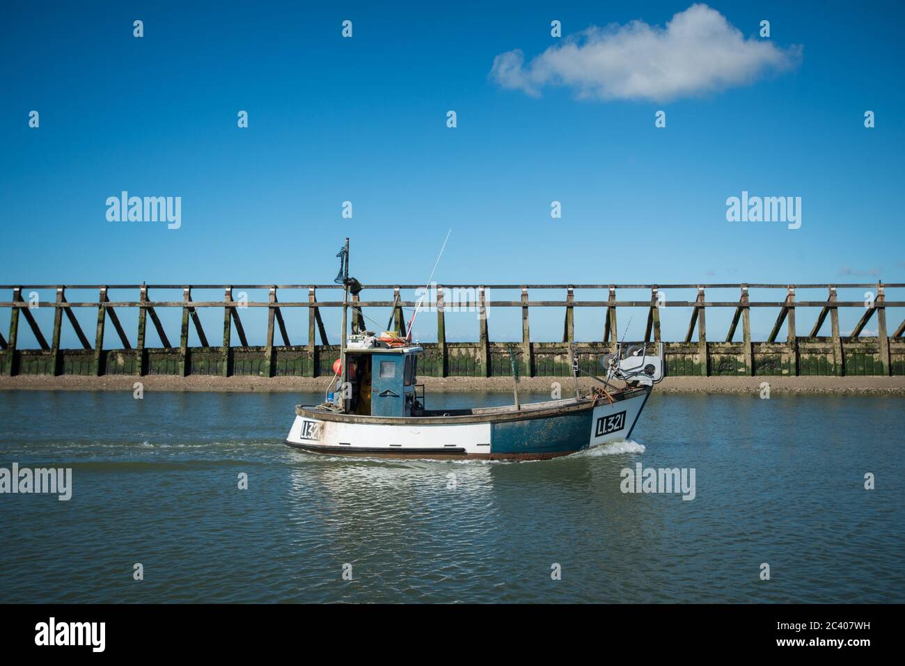 Fishing trawler returns to harbour on a summers day. Littlehampton ...