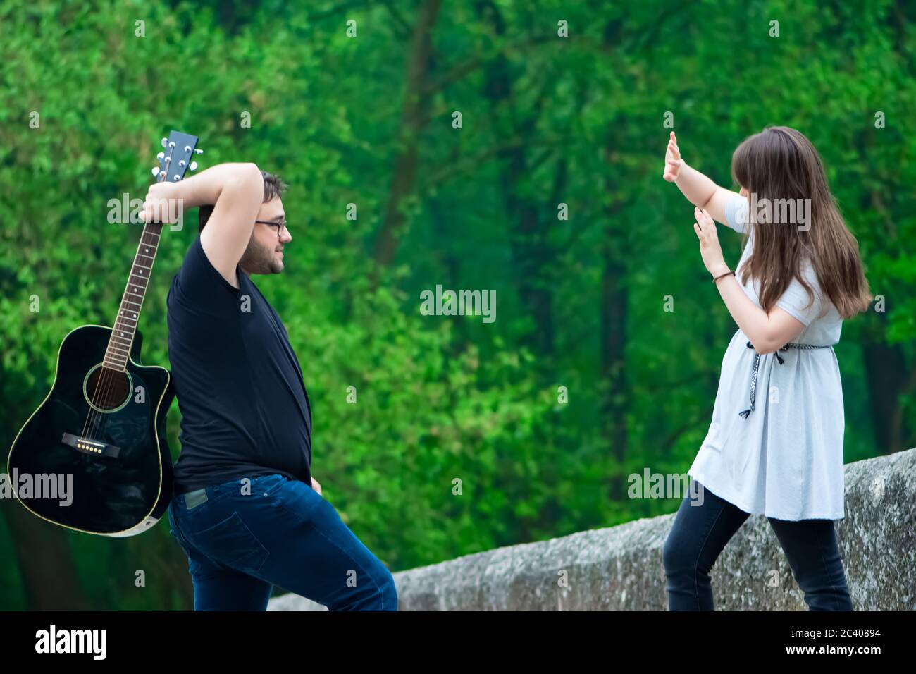 Man hitting the woman by guitar outdoor Stock Photo - Alamy
