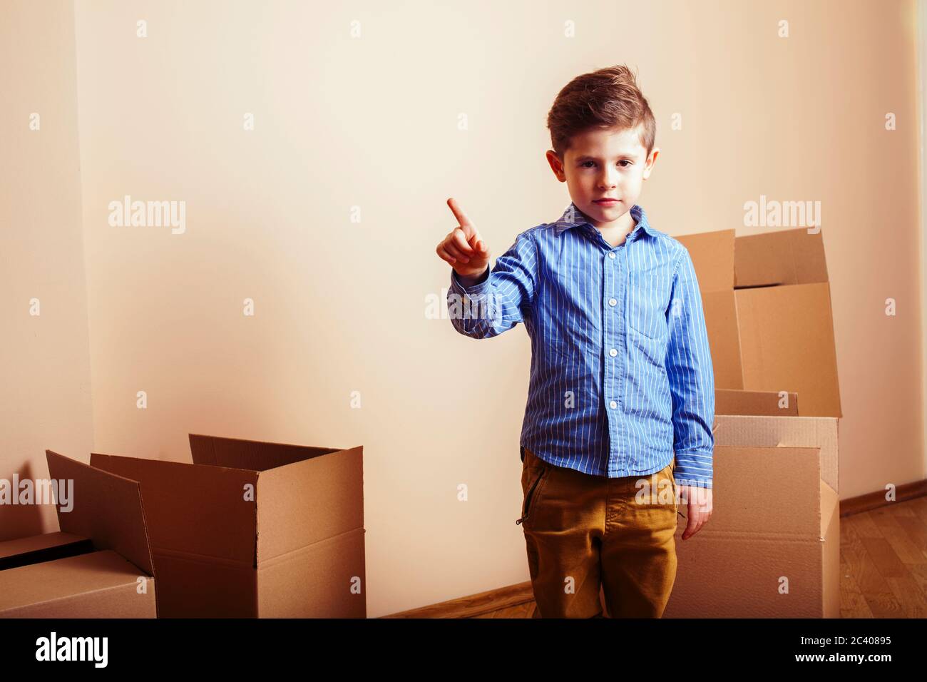 little cute boy in empty room, move to new house. home alone among ...