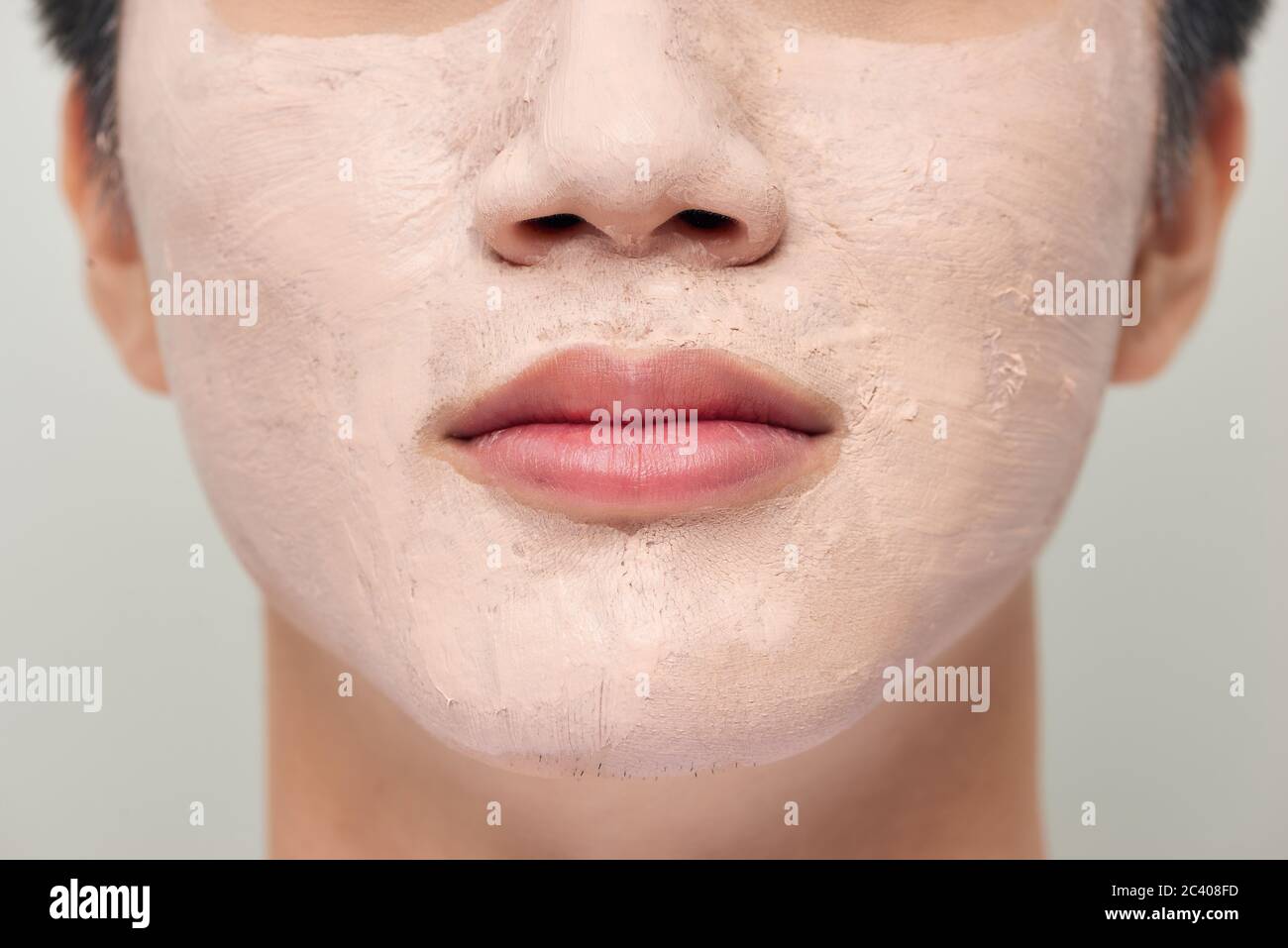 Handsome man with clay mask on his face against white background Stock ...