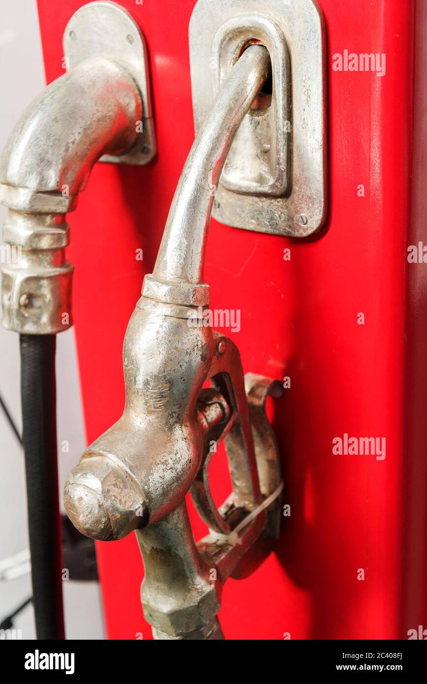 Old gas gun at a gas station in retro style. The gun is in one of the ...