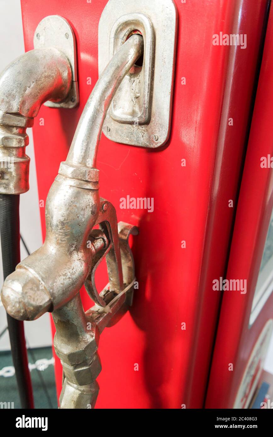 Old gas gun at a gas station in retro style. The gun is in one of the ...