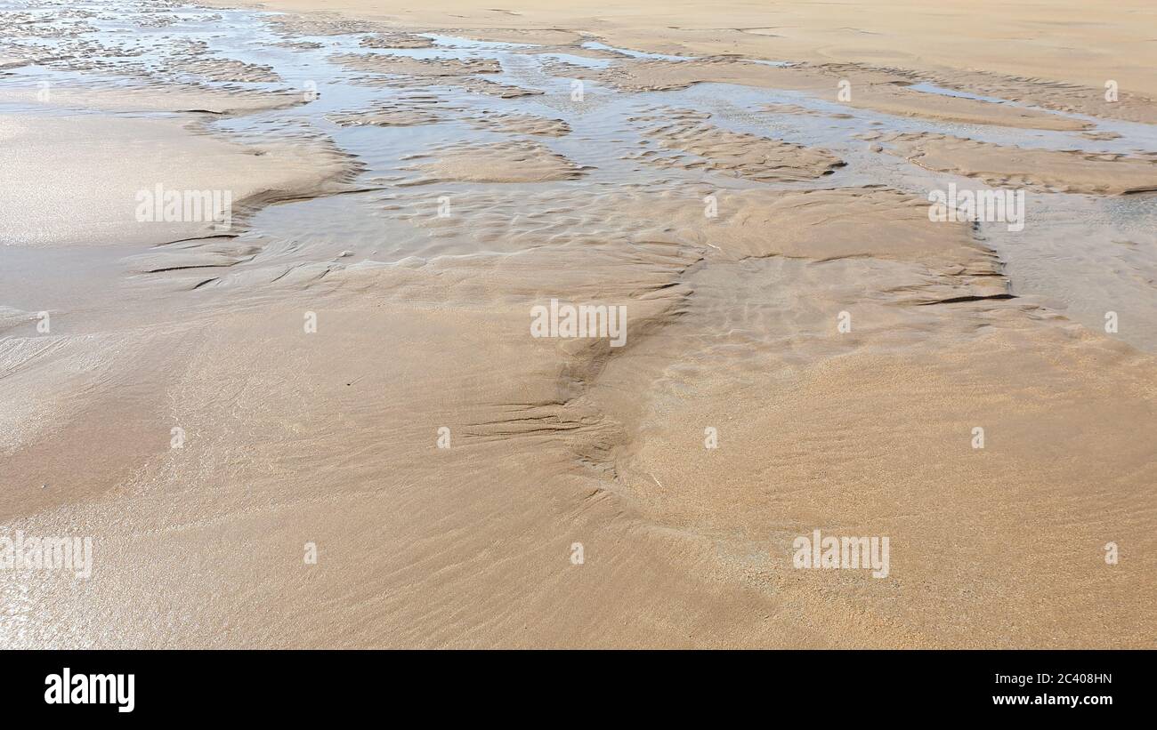 Sand and water Stock Photo - Alamy