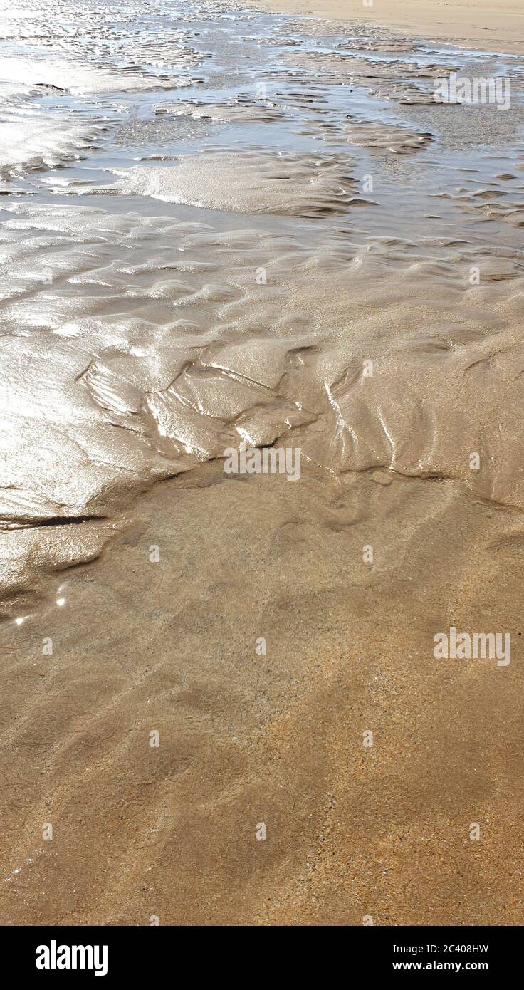 Sand and water Stock Photo - Alamy