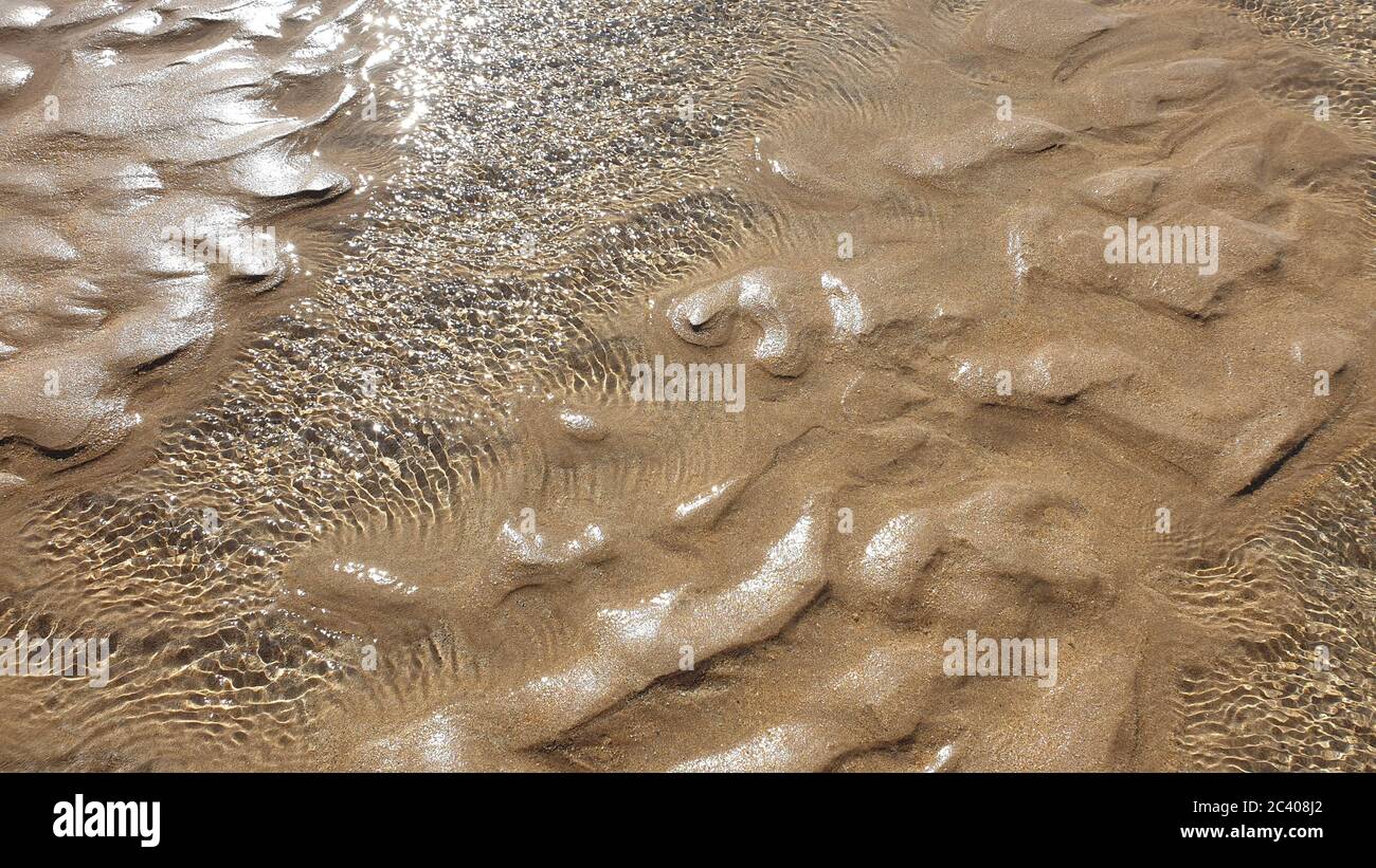 Sand and water Stock Photo - Alamy
