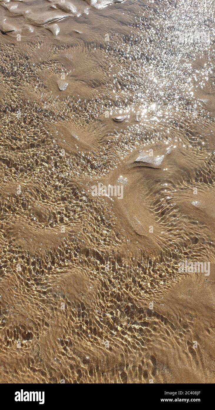 Sand and water Stock Photo - Alamy