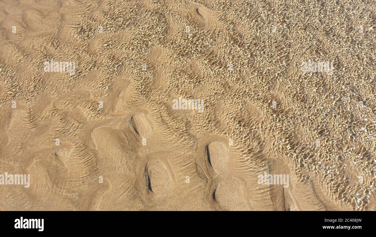 Sand and water Stock Photo - Alamy
