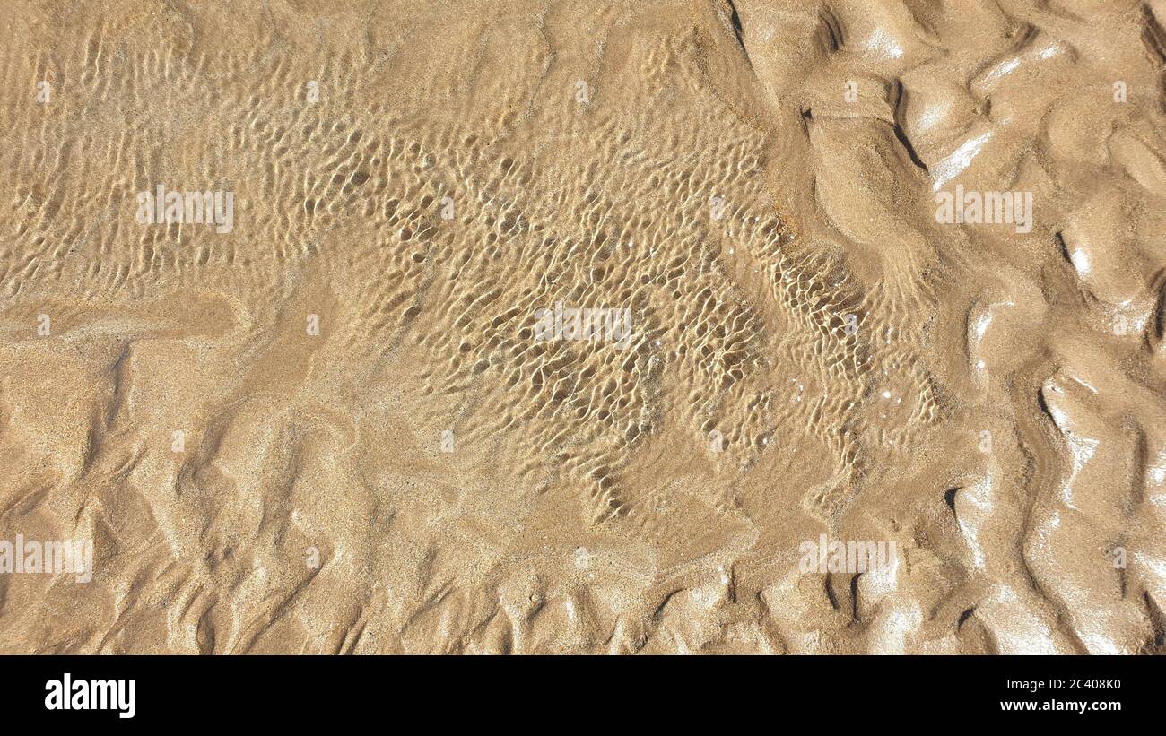 Sand and water Stock Photo - Alamy