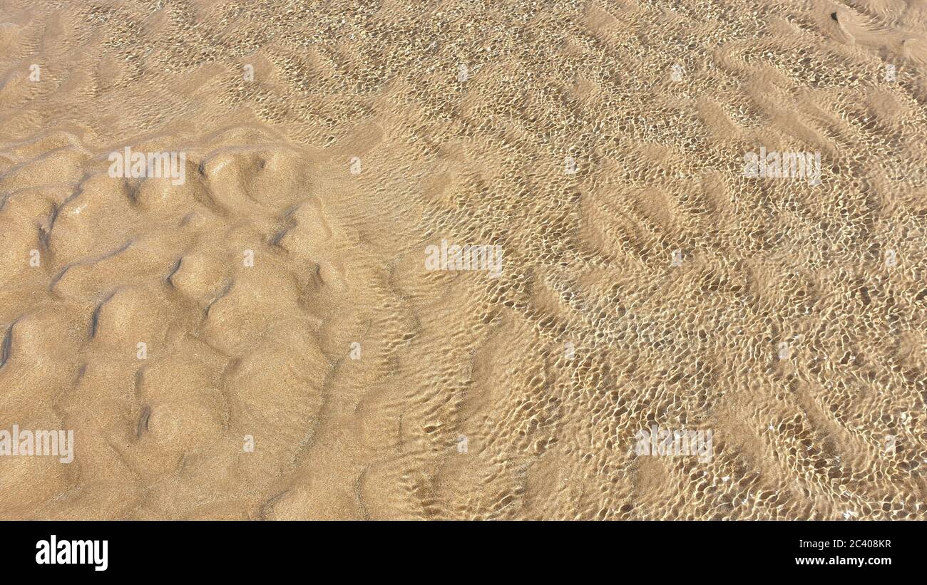 Sand and water Stock Photo - Alamy