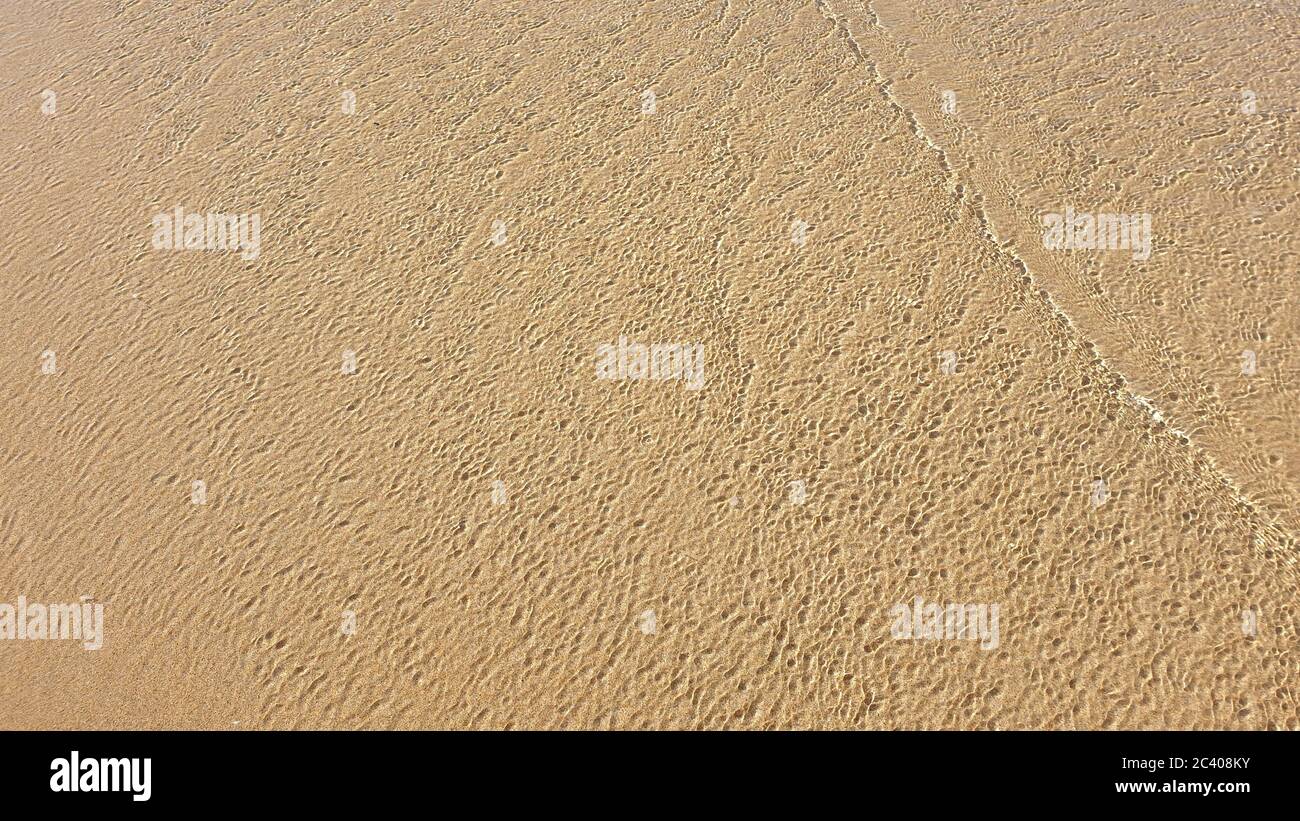 Sand and water Stock Photo - Alamy