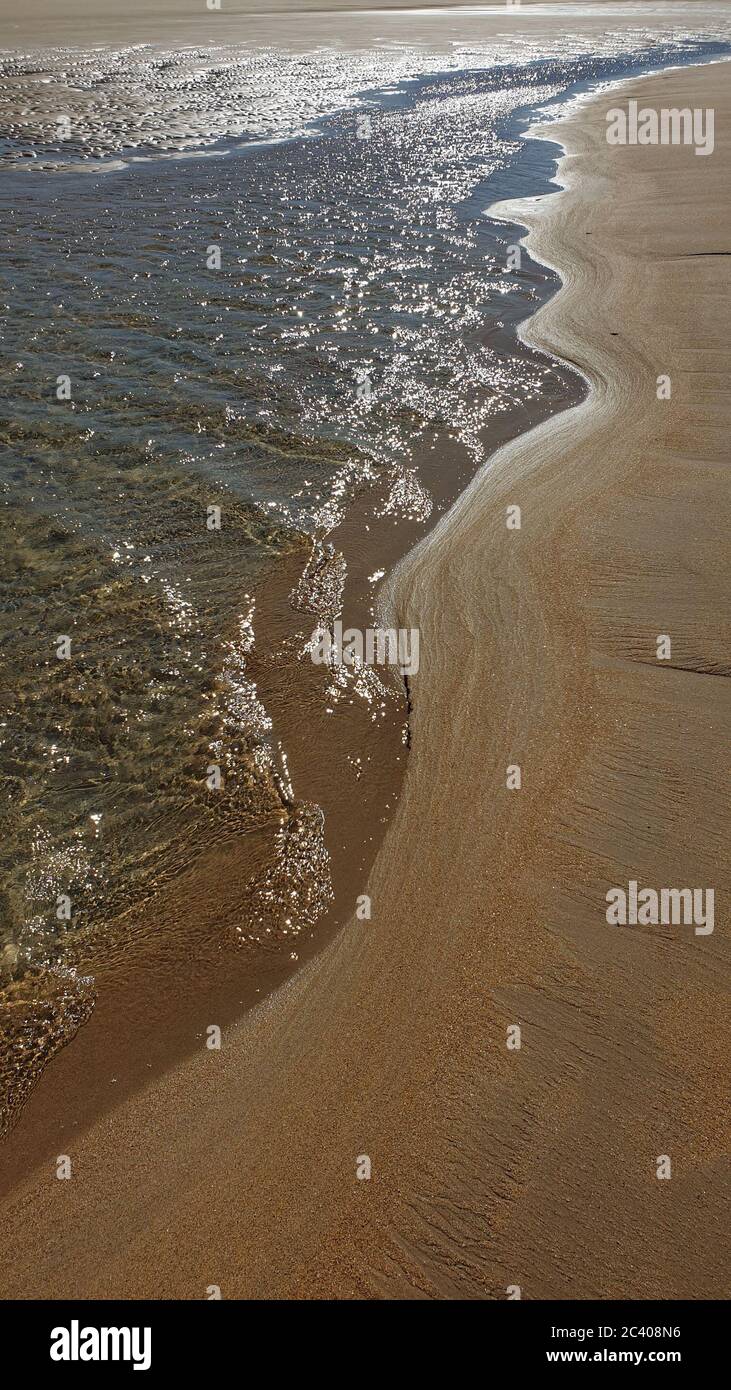 Sand and water Stock Photo - Alamy
