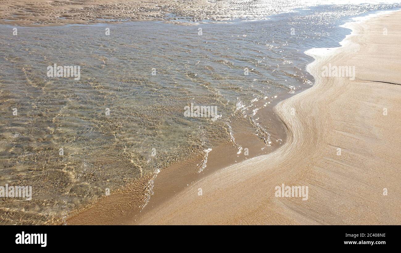 Sand and water Stock Photo - Alamy