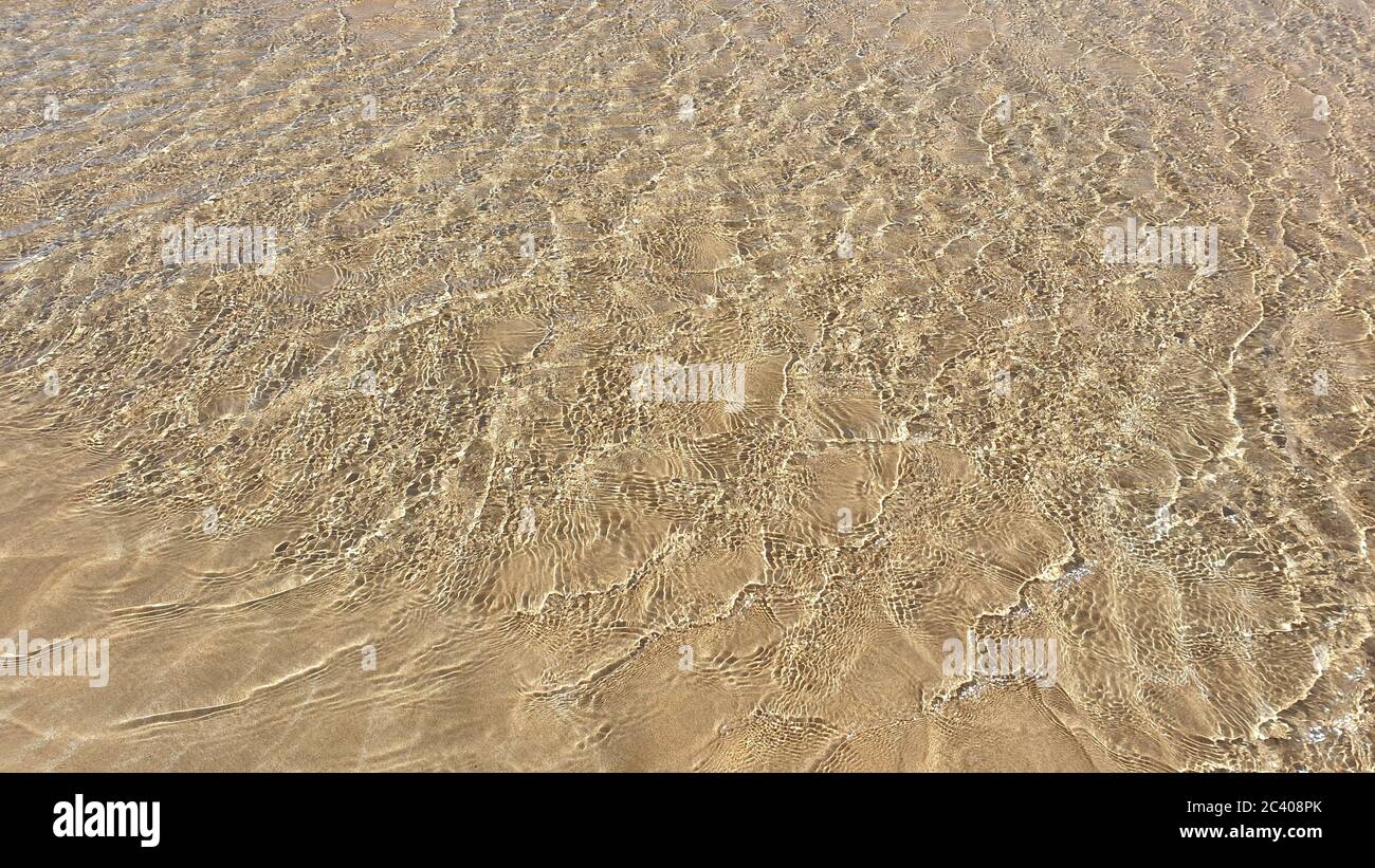 Sand and water Stock Photo - Alamy
