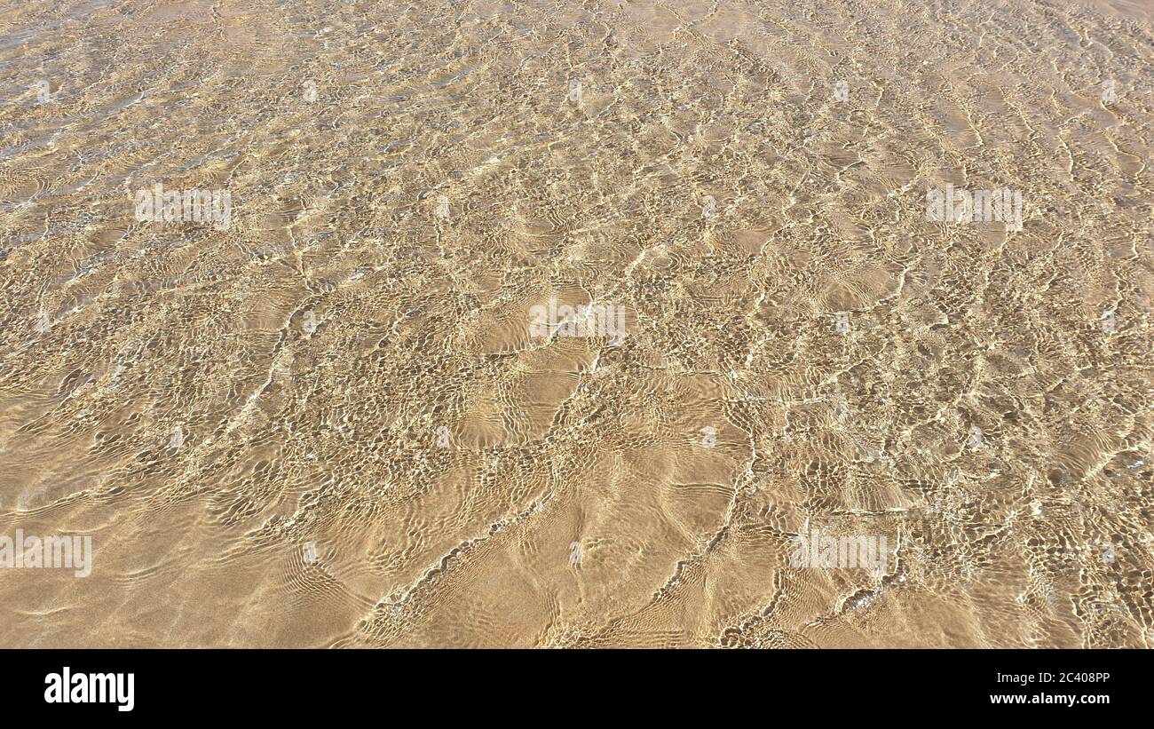 Sand and water Stock Photo - Alamy