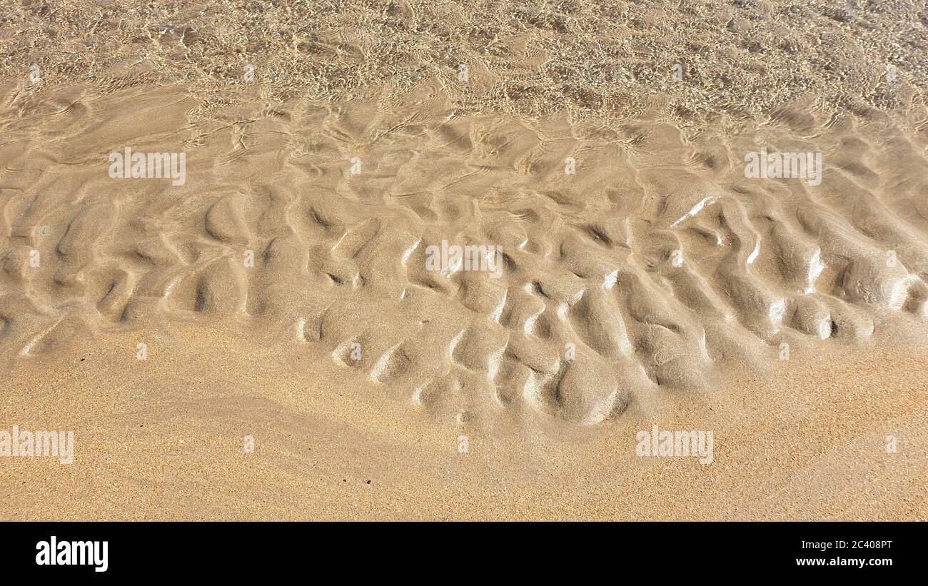 Sand and water Stock Photo - Alamy