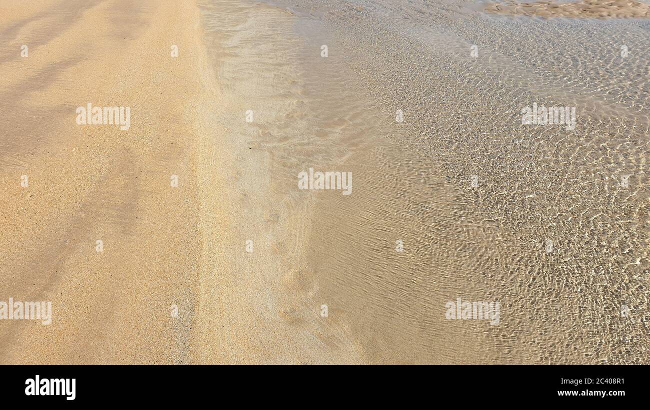 Sand and water Stock Photo - Alamy