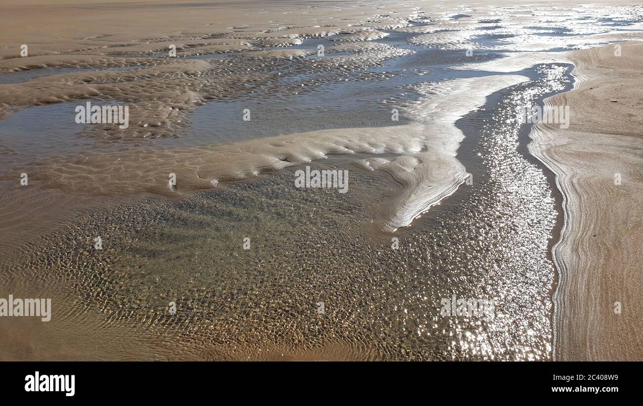 Sand and water Stock Photo - Alamy