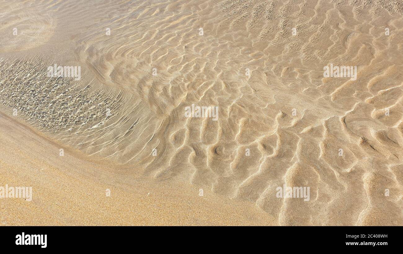 Sand and water Stock Photo - Alamy