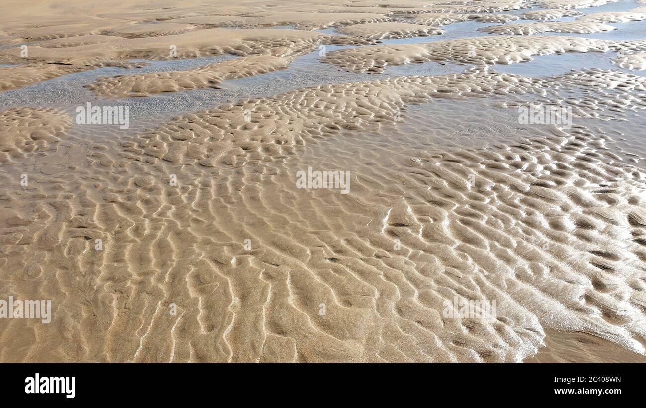 Sand and water Stock Photo - Alamy