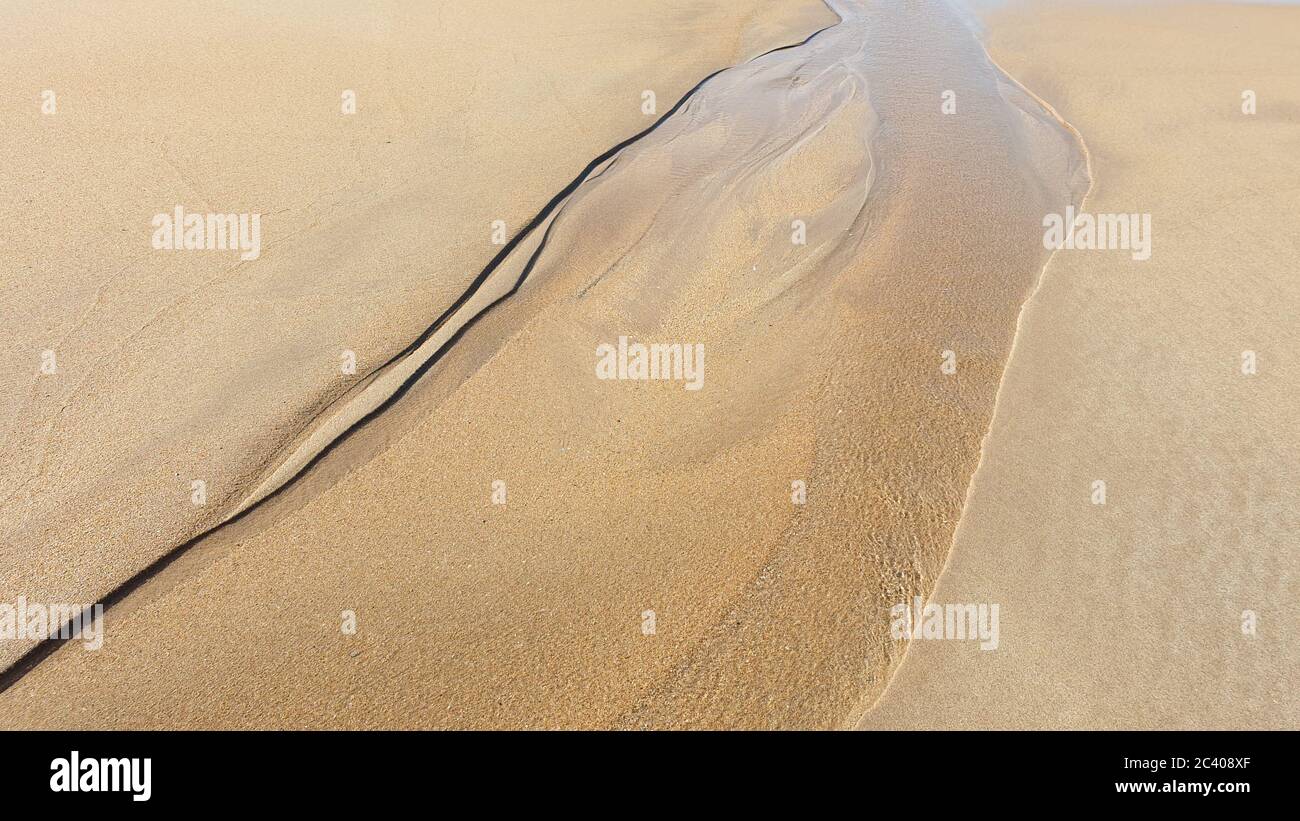 Sand and water Stock Photo - Alamy