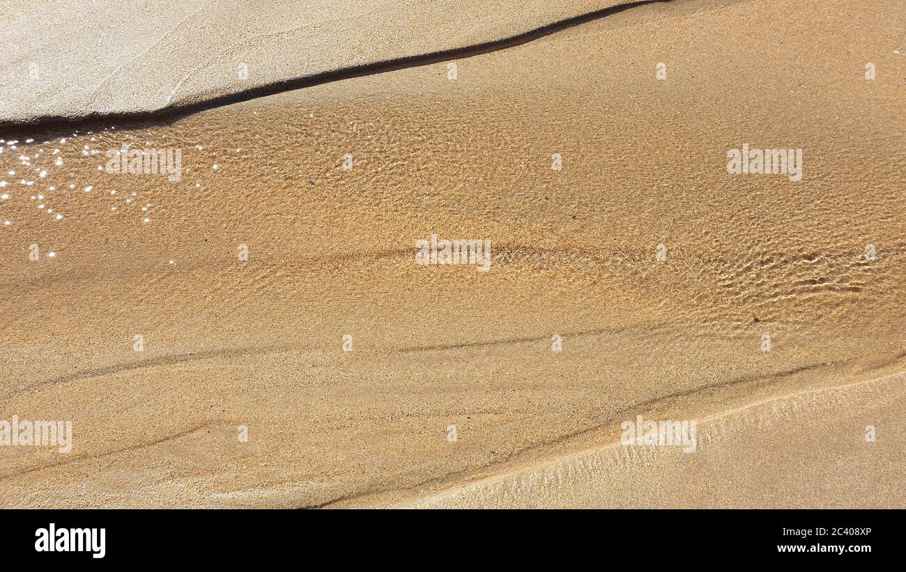 Sand and water Stock Photo - Alamy