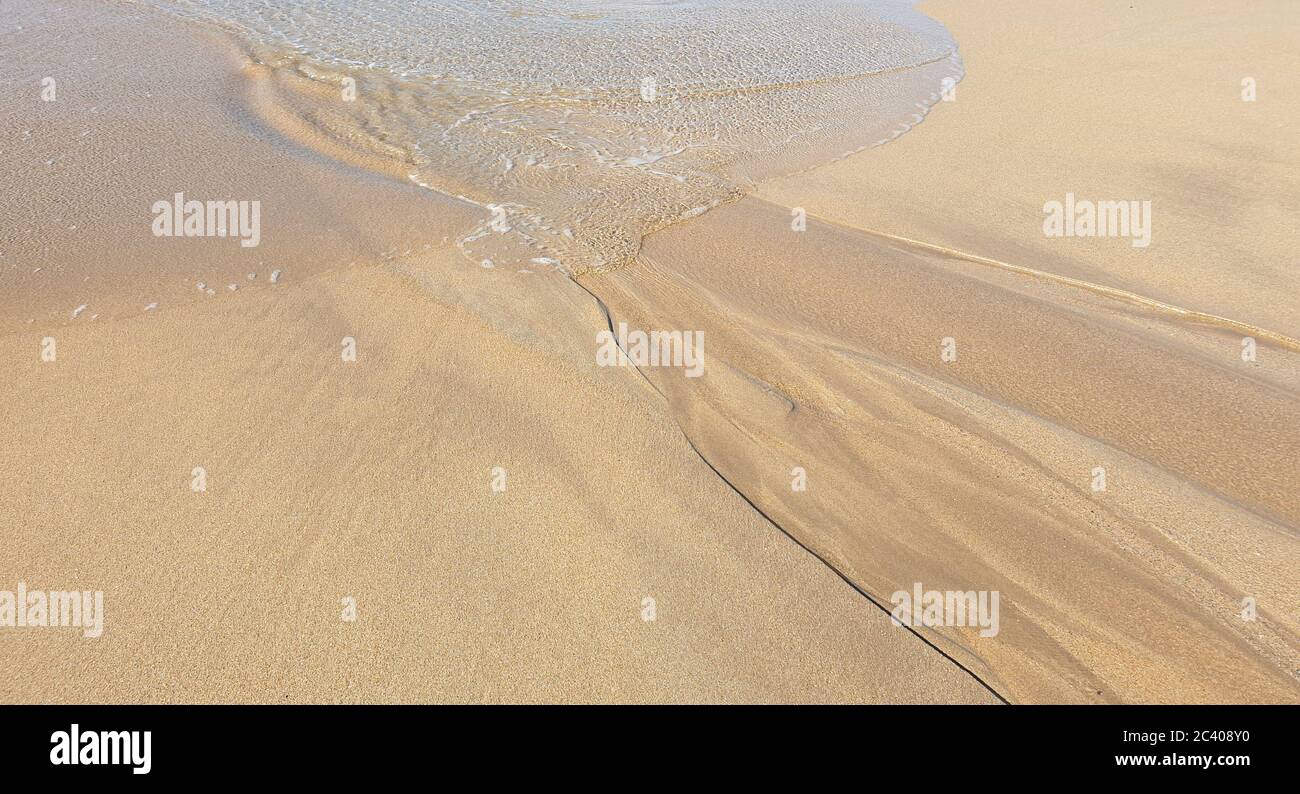 Sand and water Stock Photo - Alamy