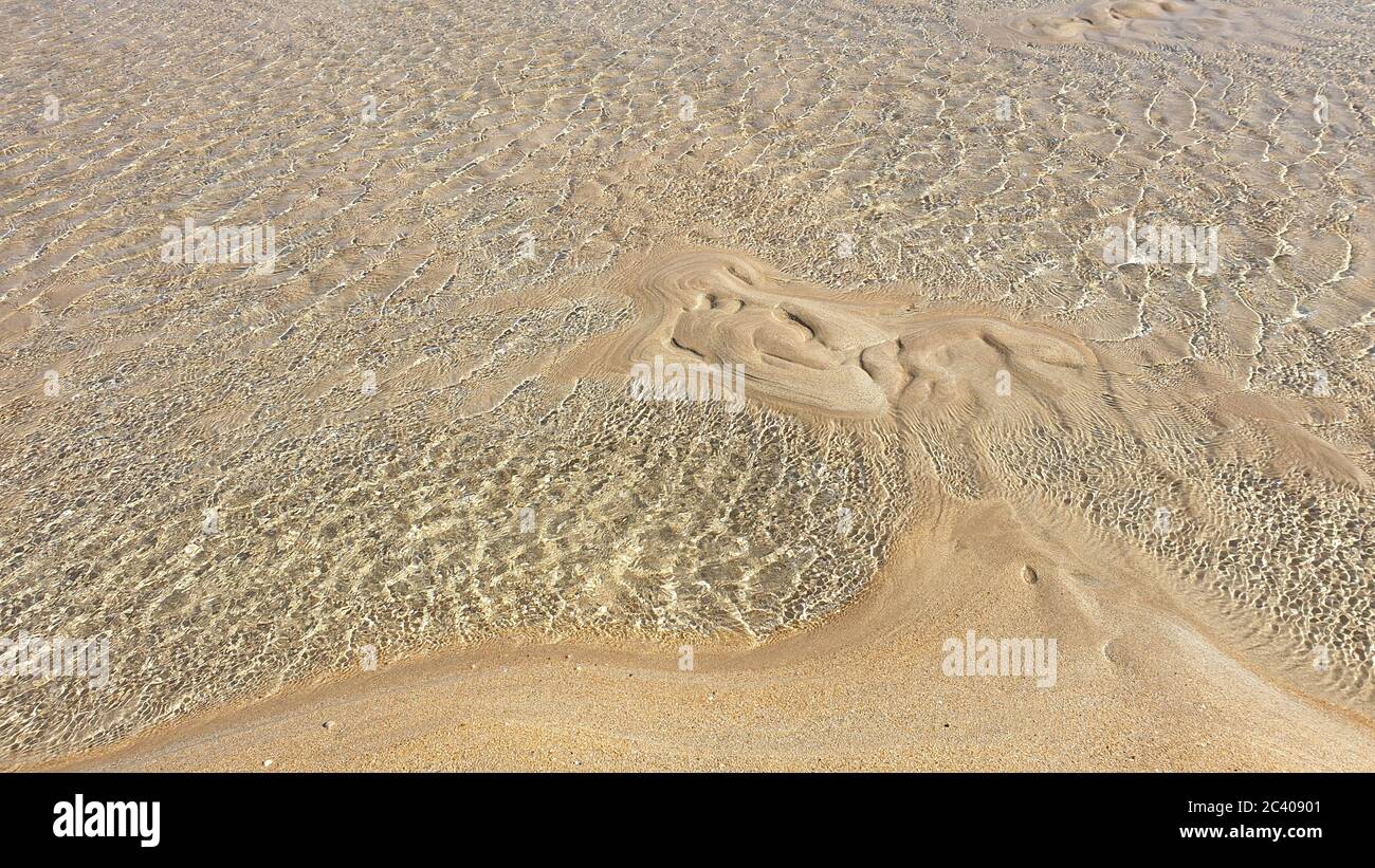 Sand and water Stock Photo - Alamy