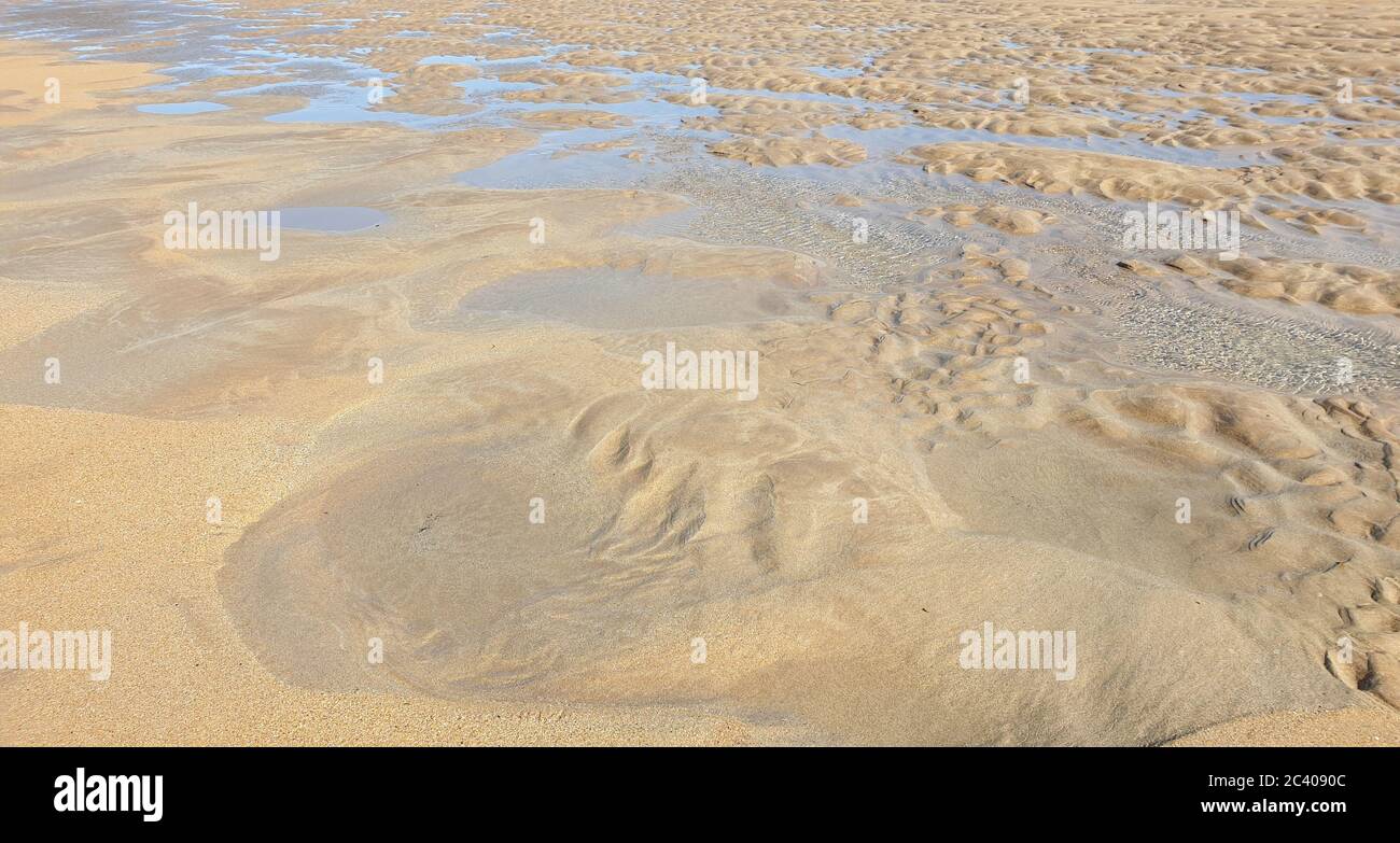 Sand and water Stock Photo - Alamy