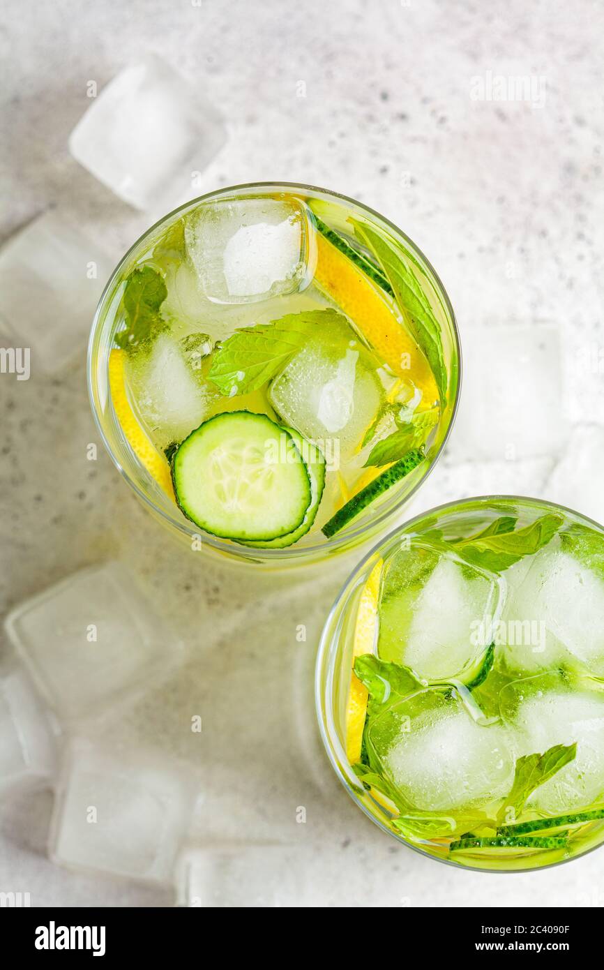 Detox sassy water with cucumber and lemon in glasses, light background ...